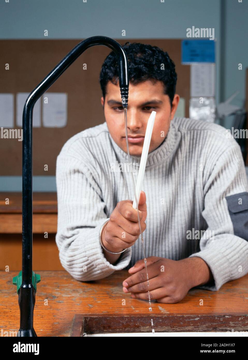 Electrostatics experiment. Student holding an electrostatically charged ...