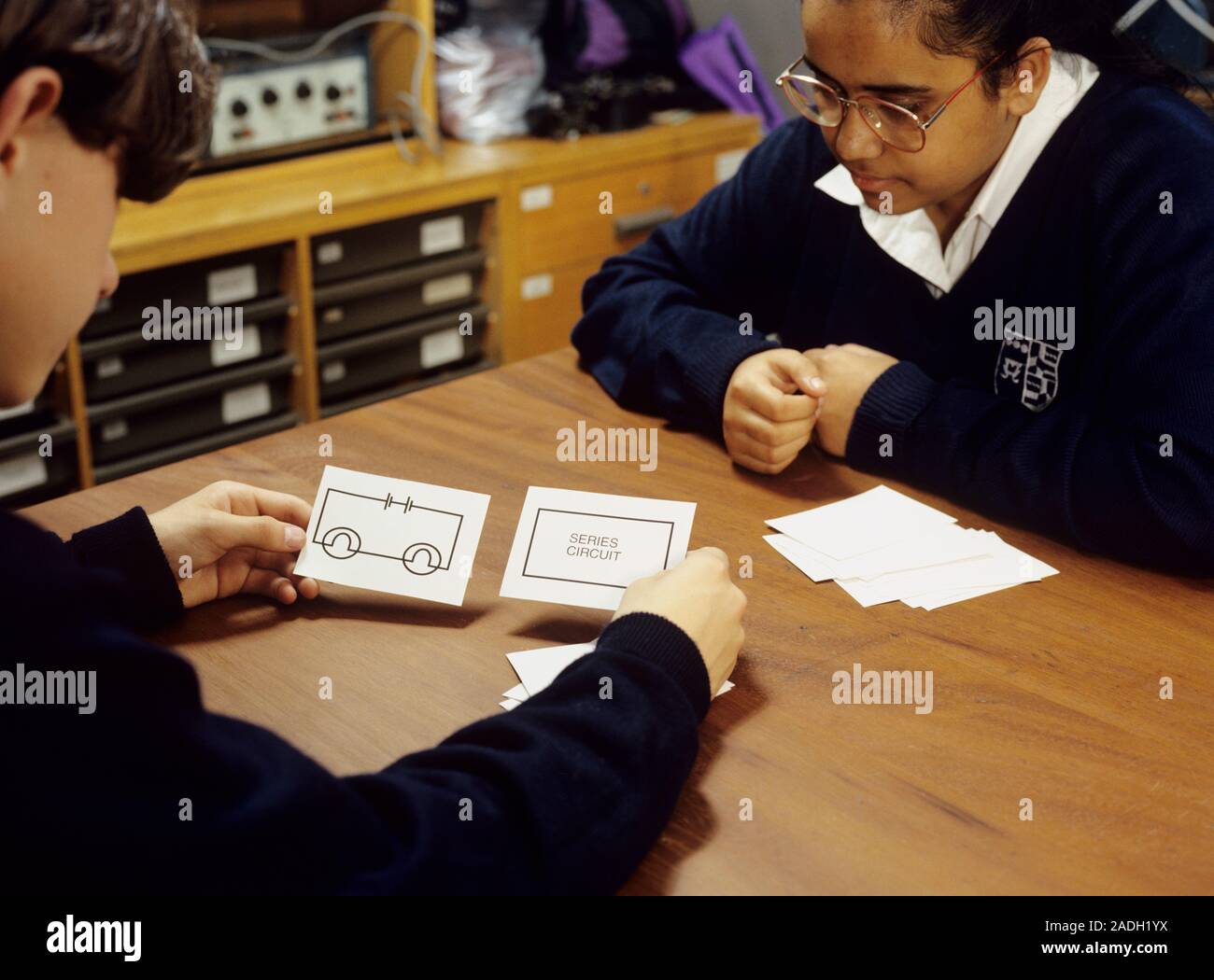 MODEL RELEASED. Pupils learning about circuits. Two schoolchildren play ...