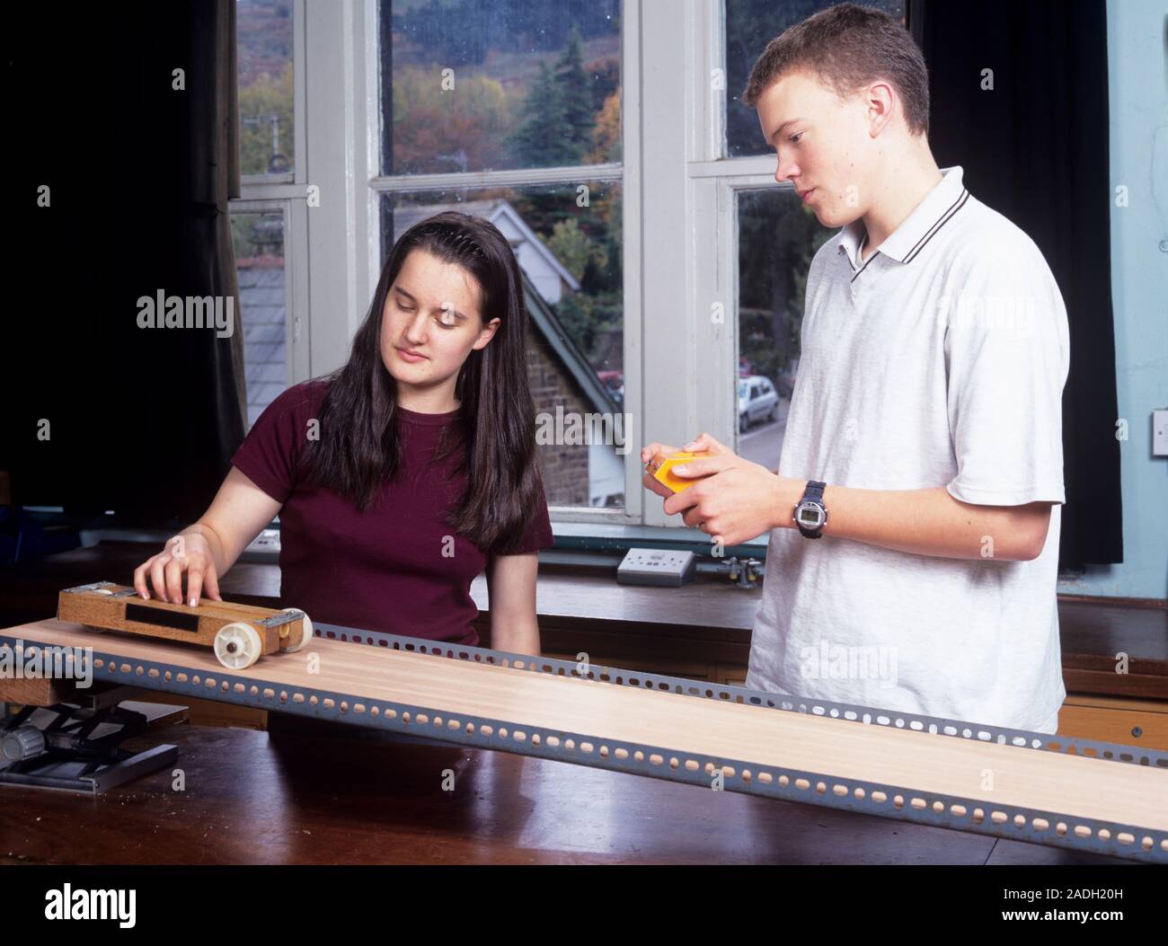 MODEL RELEASED. Students with a trolley on a ramp. This apparatus could ...