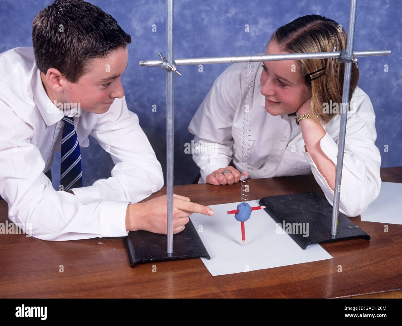 MODEL RELEASED. Seismometer experiment. Two pupils with a makeshift ...