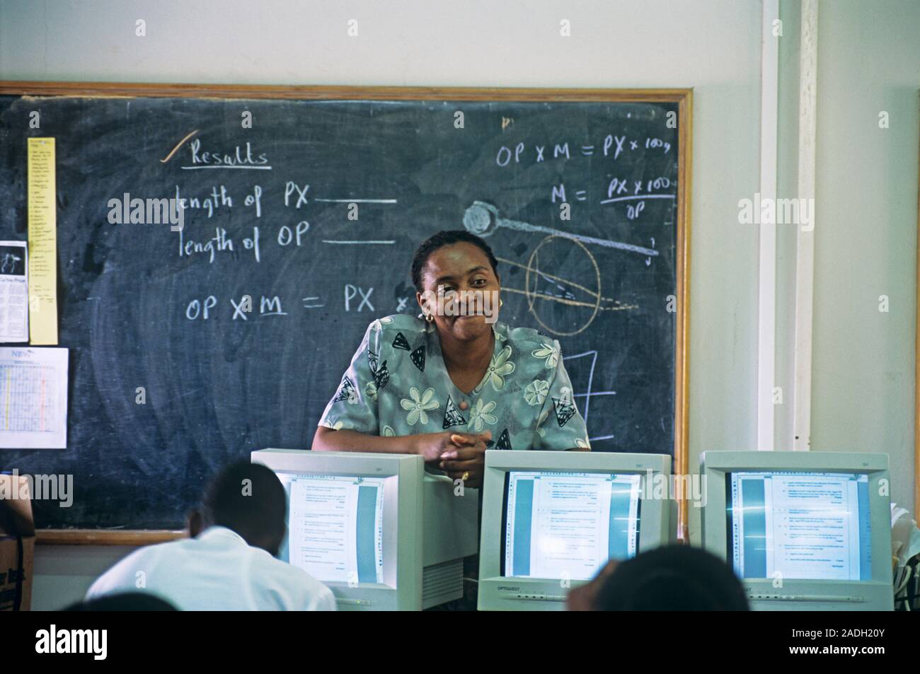Science lesson. Teacher in front of a blackboard during a science ...