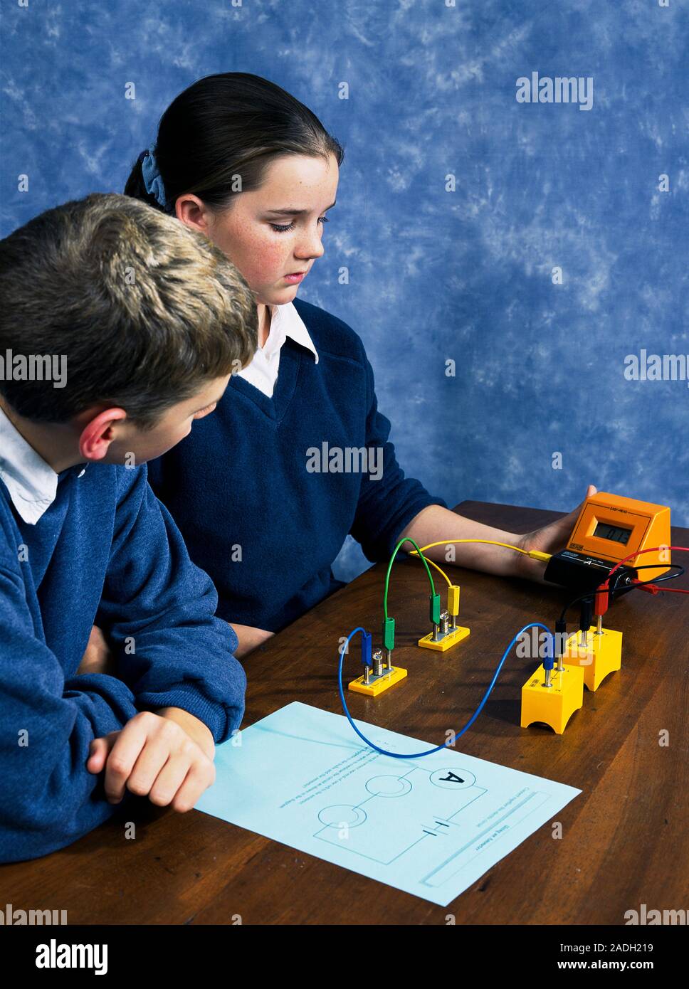 Physics experiment. Schoolchildren experimenting on a simple electrical ...