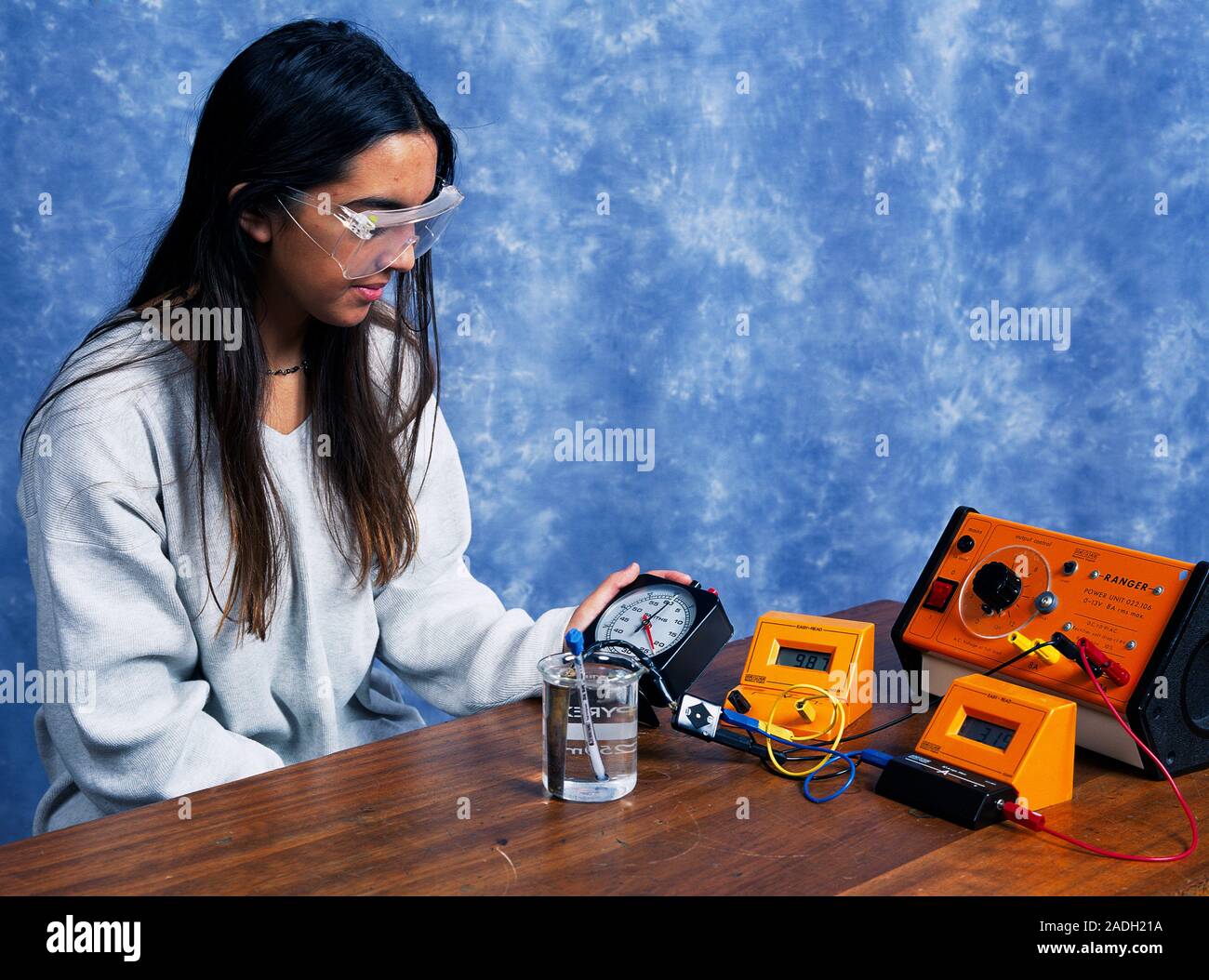 Physics experiment. Schoolchild timing an experiment to electrically ...