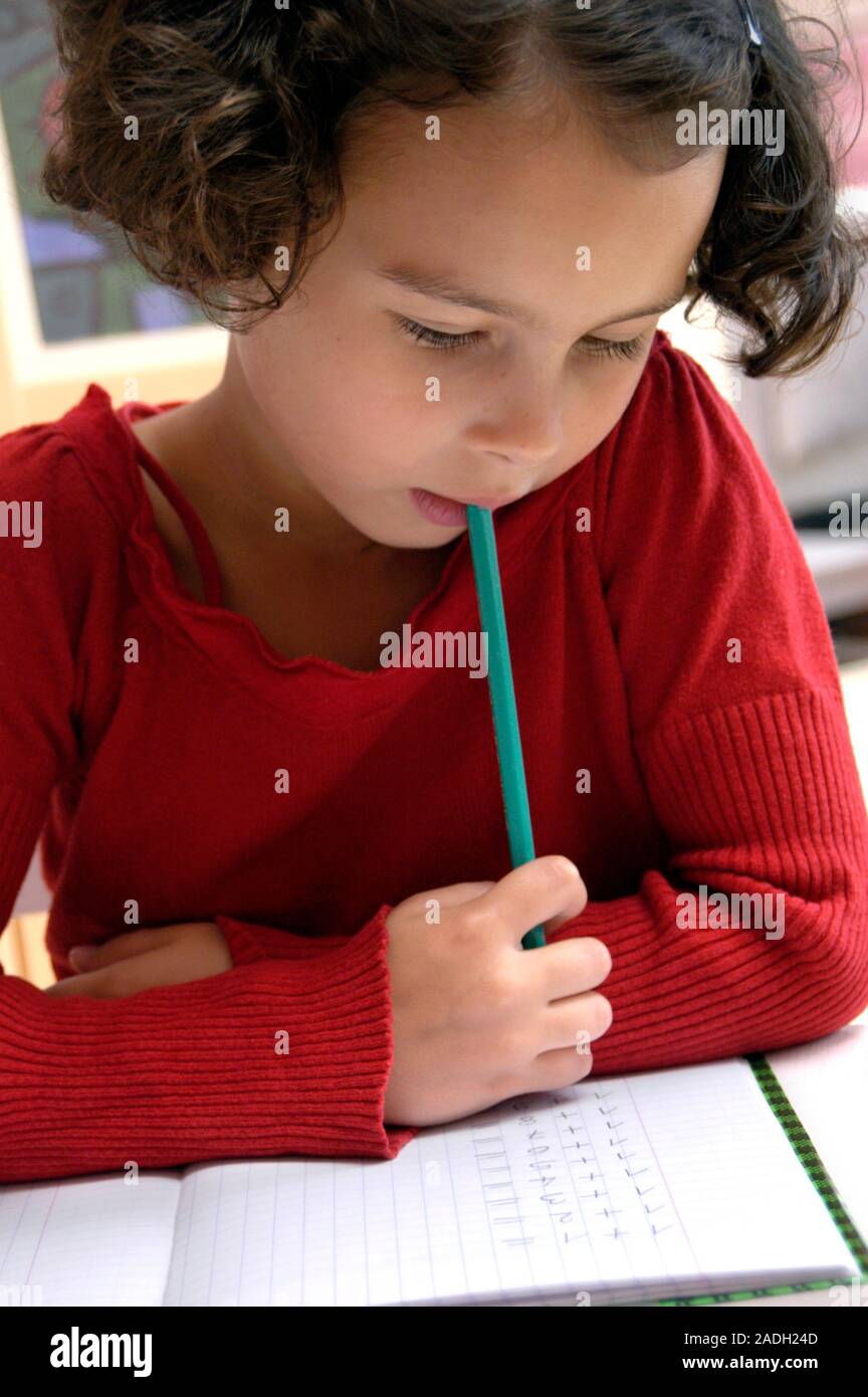 MODEL RELEASED. Writing practice. Six year old girl writing the letters ...