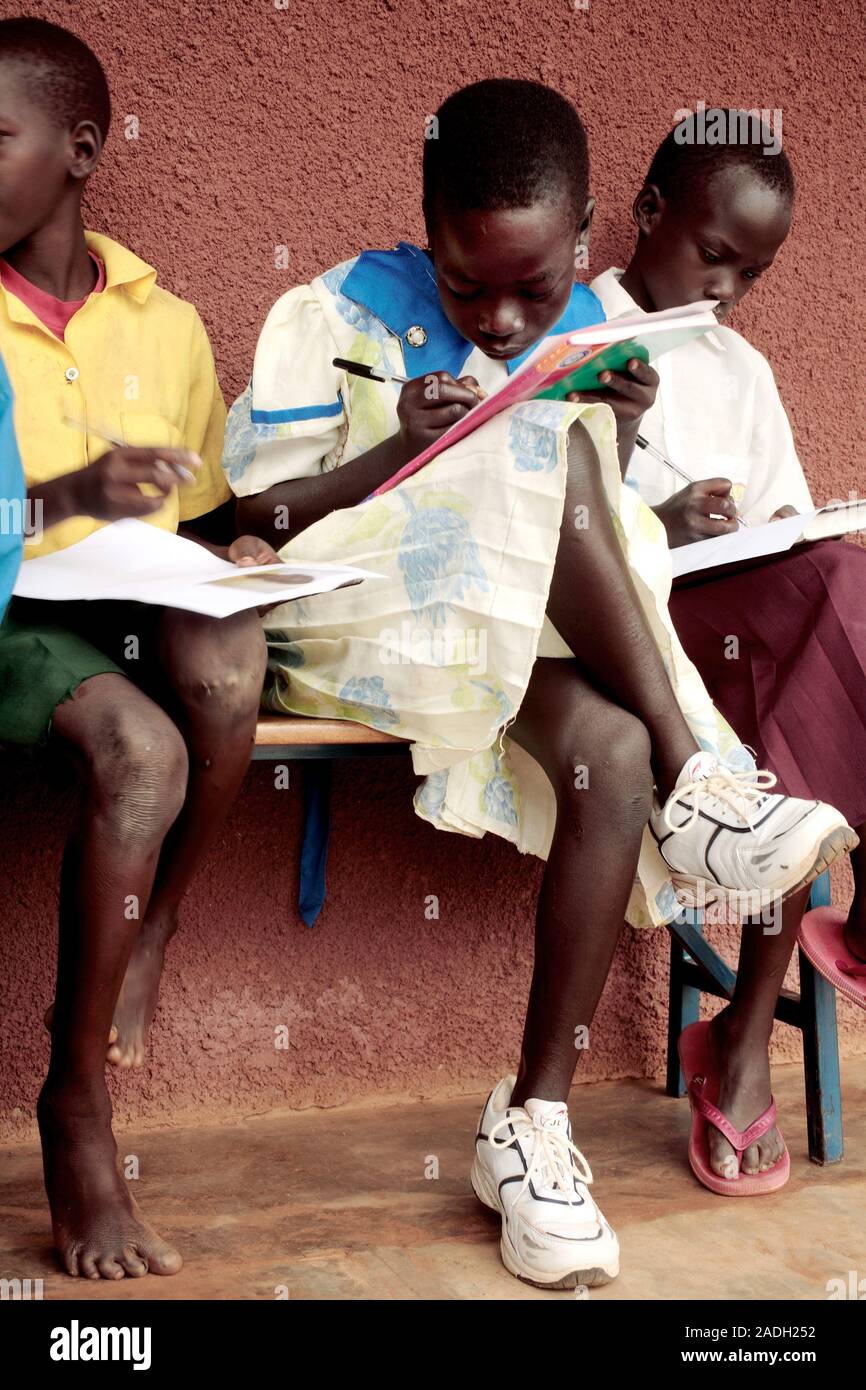 Orphanage school. Students using pens and paper during a school lesson ...