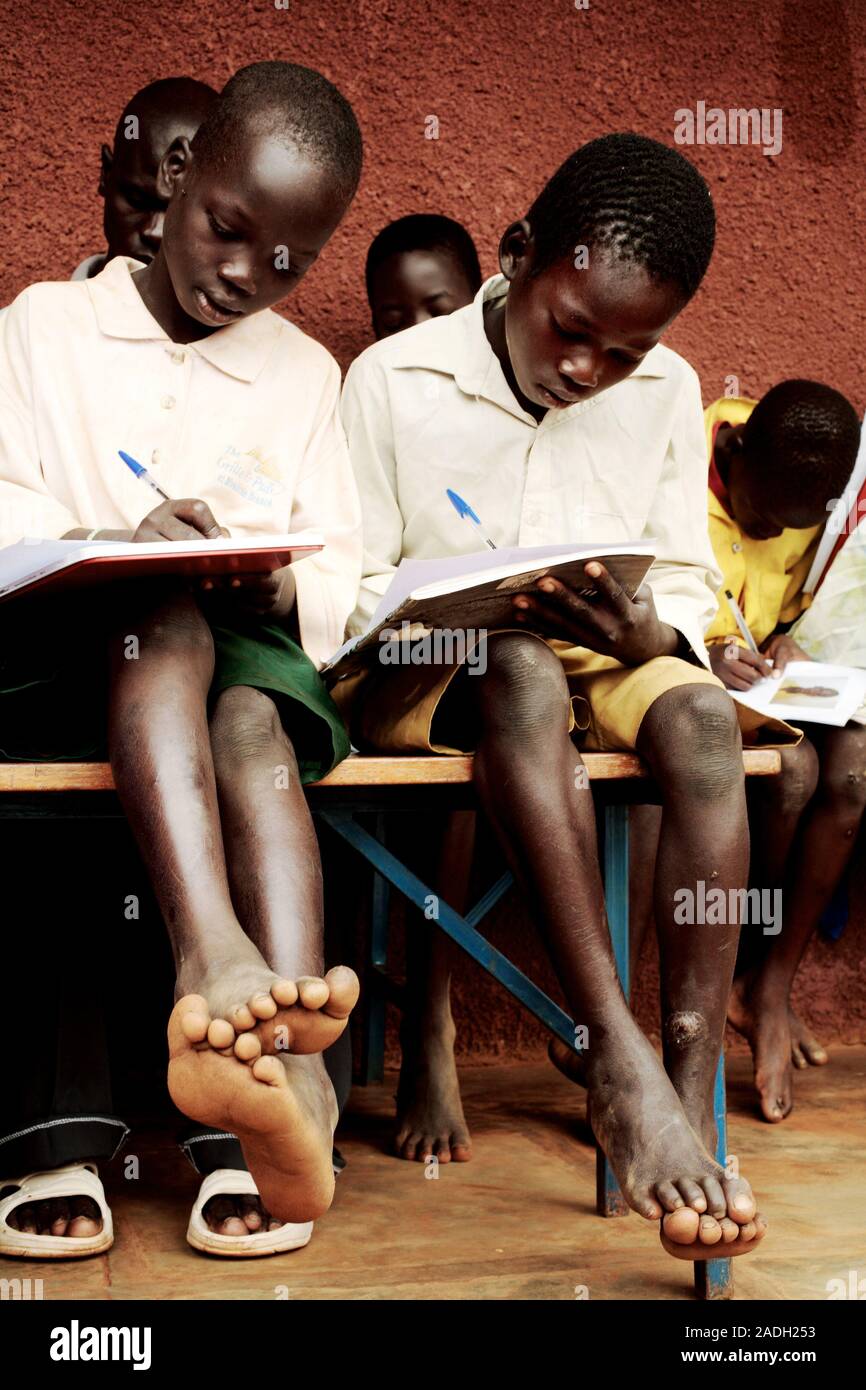 Orphanage school. Students using pens and paper during a school lesson ...