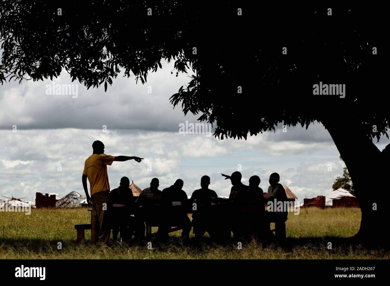 MODEL RELEASED. Outdoor school lesson. Teacher teaching a group of ...