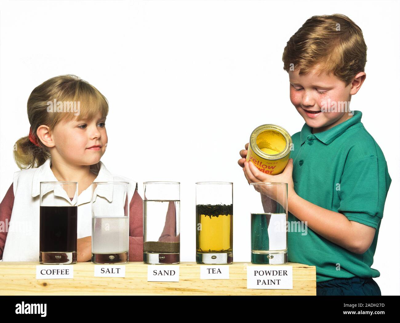 Solubility experiment. Boy and girl testing various substance ...