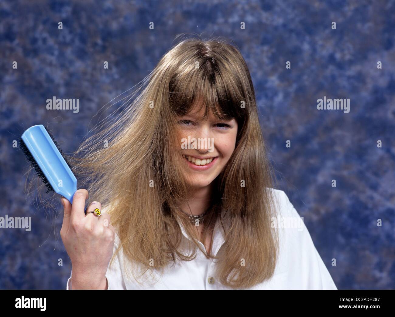 Girl with statically charged hair. When the girl combs her hair ...