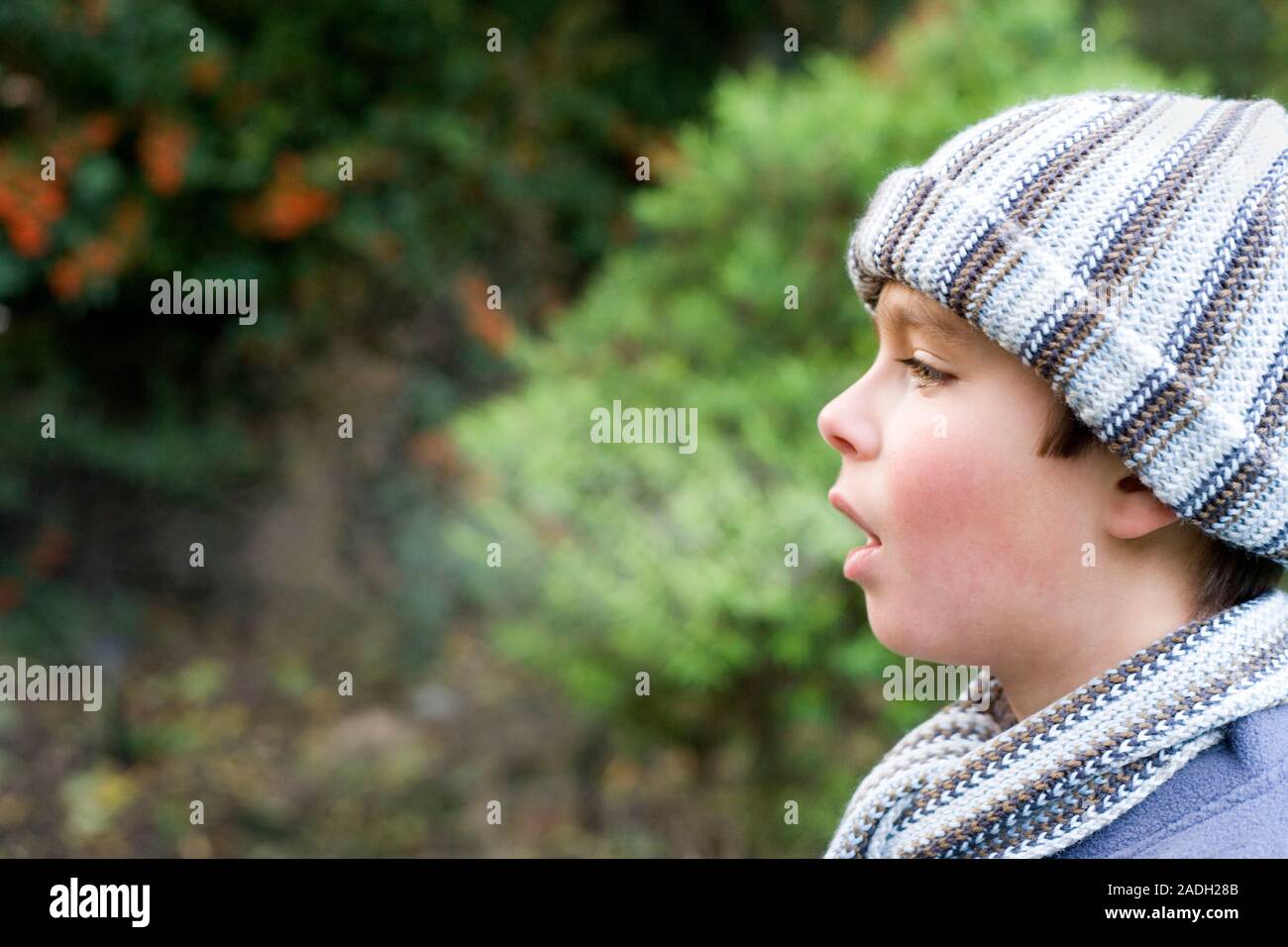 MODEL RELEASED. Breath condensing in cold air. Boy watching the water ...