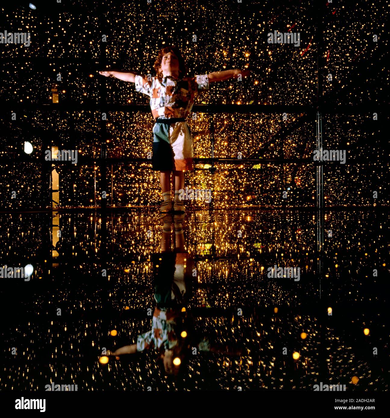 Infinity Room. Boy standing in the Infinity Room, which has mirrored ...