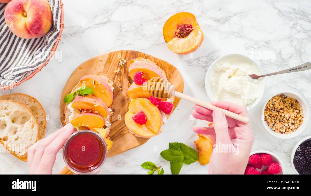 Flat lay. Step by step. Making ricotta toasts with organic peaches and ...