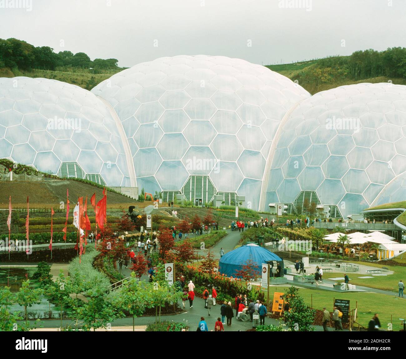 Eden Project. Visitors outside the humid tropics biome (dome) at the ...