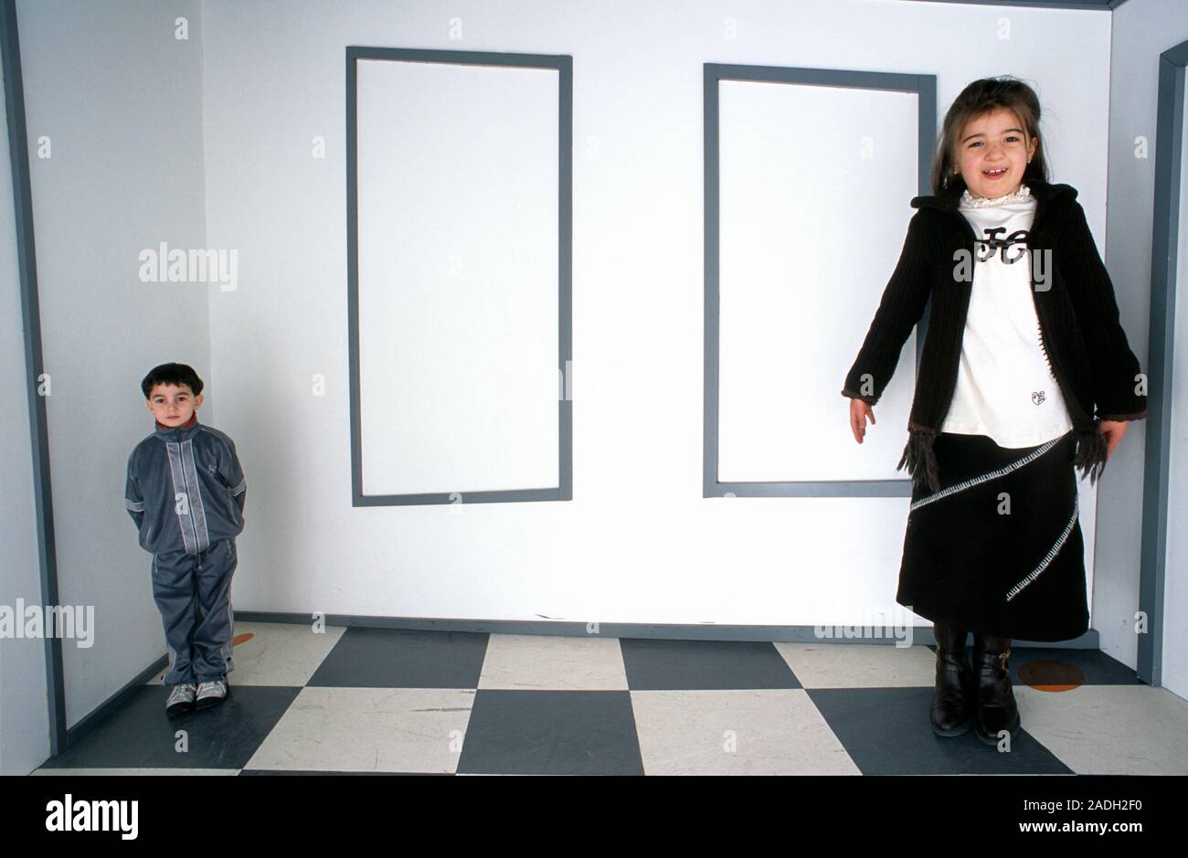 Optical illusion exhibit. Children standing in a science exhibit in ...