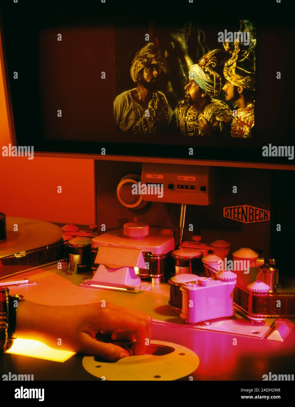 Film editing. Hands using a Steinbeck machine to edit a film. The ...