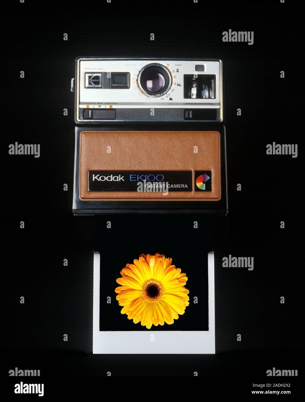 Instant camera. Developed film emerging from an instant camera. This is ...
