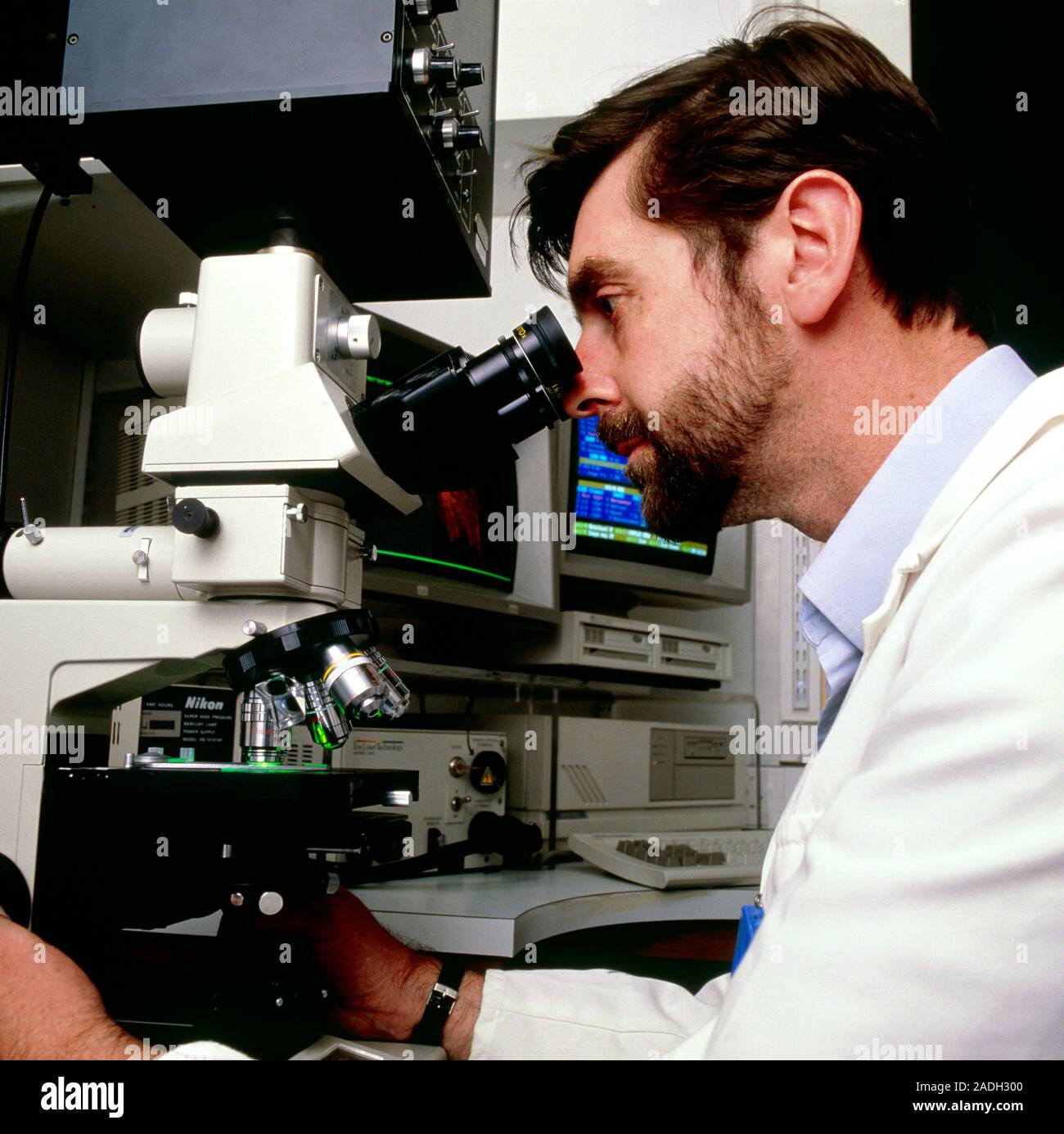 Cancer researcher using confocal microscope. A cancer research ...