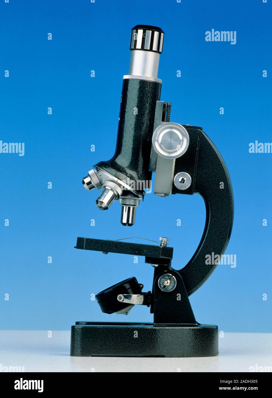 Microscope. An optical (light) microscope with a mirror for reflecting ...