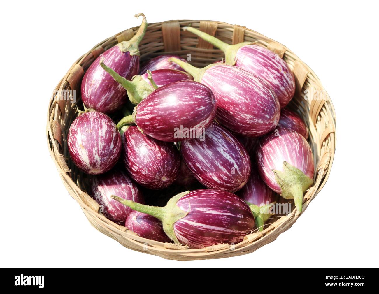 Fresh Indian Brinjals placed in Bamboo basket on a white background ...