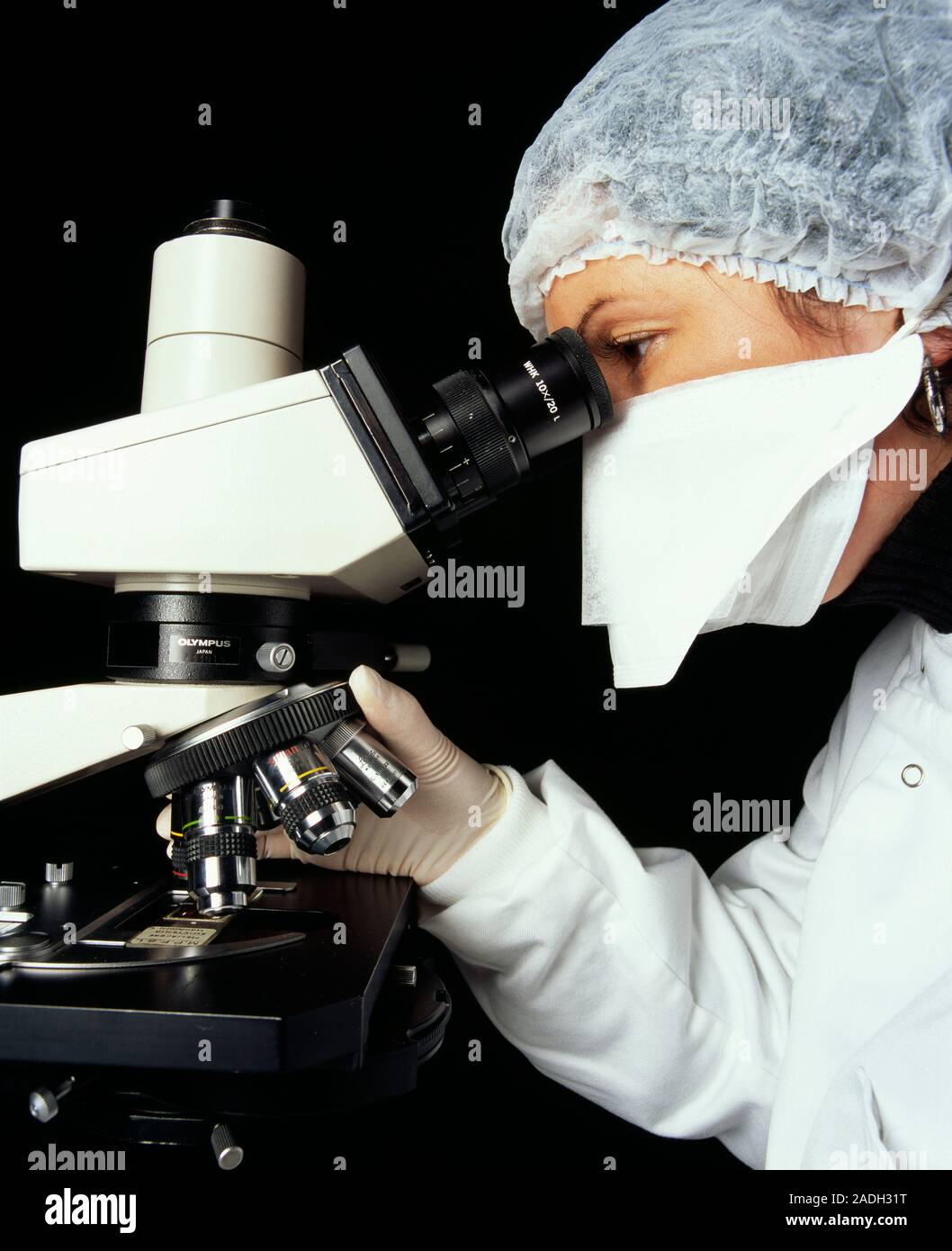 Light microscopy. Researcher using a light microscope to view a ...