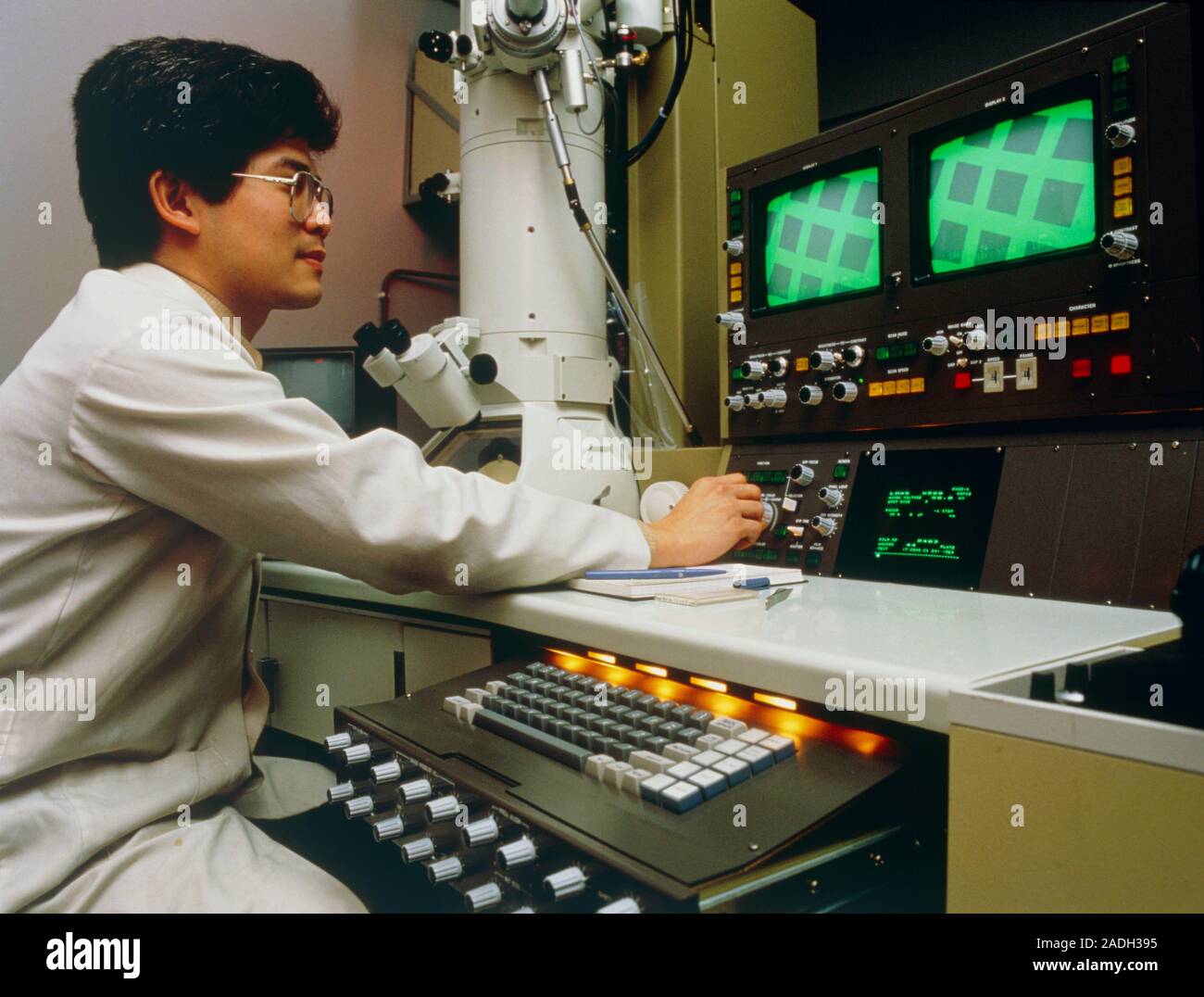 Scientist using a scanning transmission electron microscope (STEM). A ...