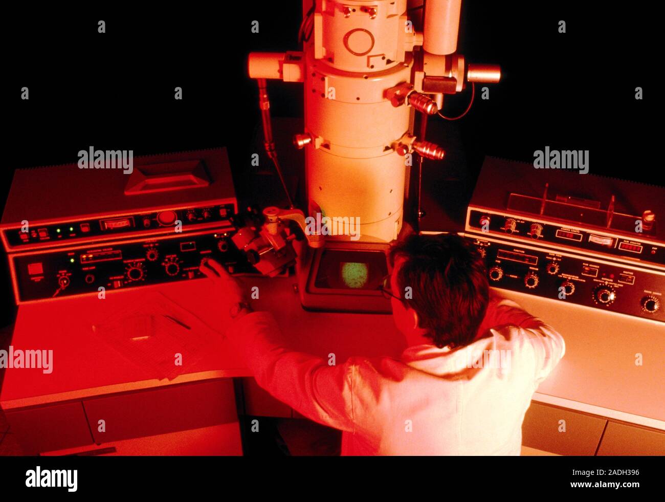 Scientist operating a transmission electron microscope (TEM). The TEM ...