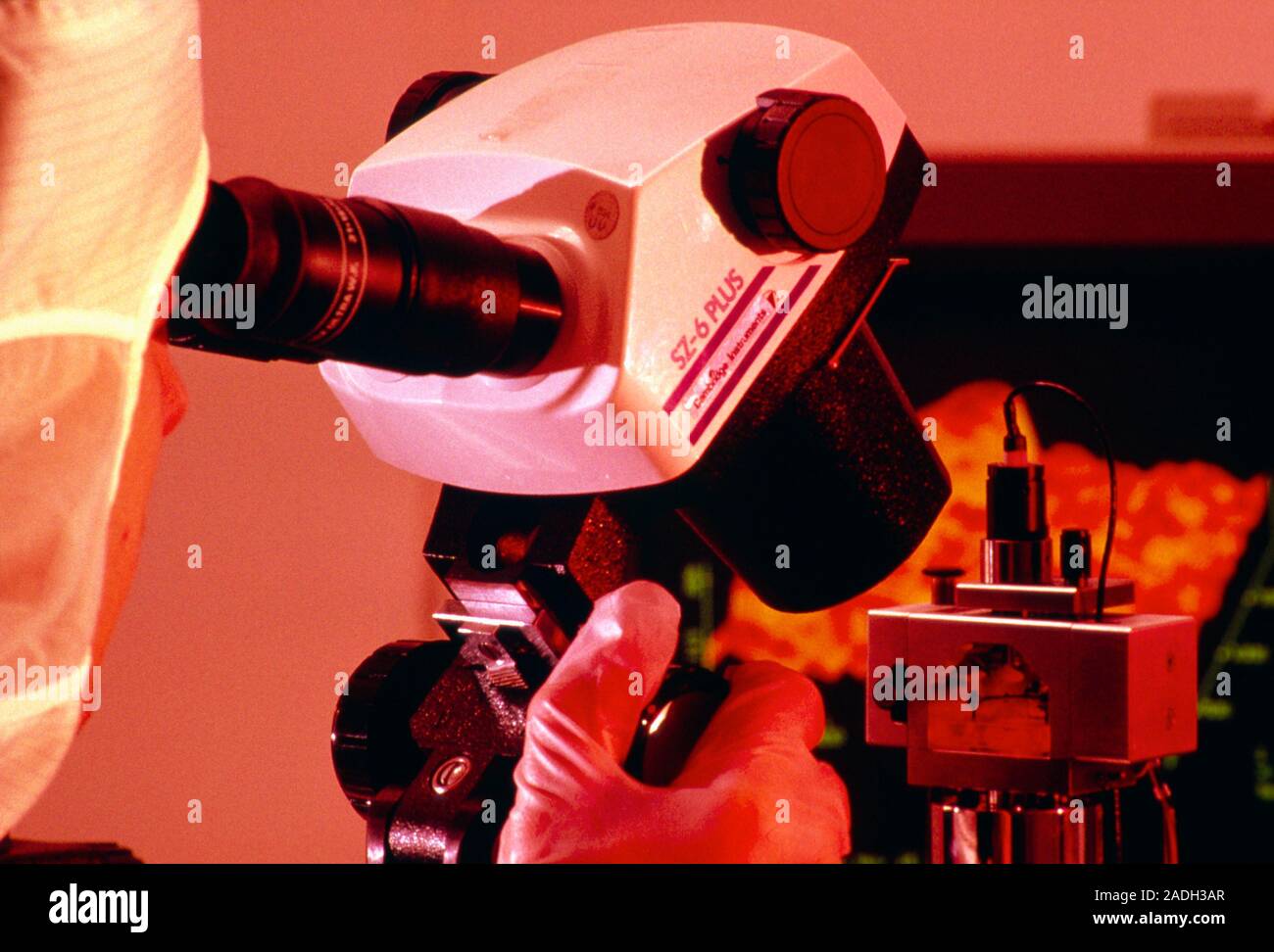 A researcher setting up an atomic force microscope (AFM), ready for use ...