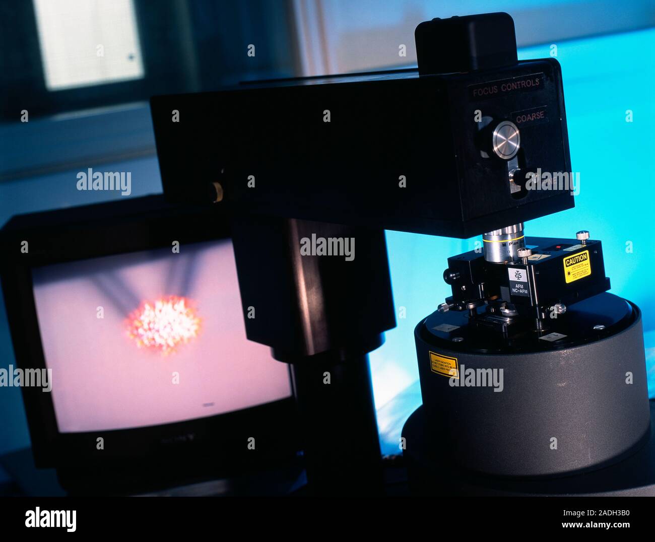 Atomic force microscope. Television screen (left) displaying a specimen ...