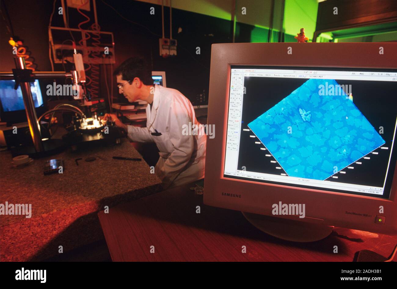 Atomic force microscopy. Researcher examining the surface of a CD-ROM ...