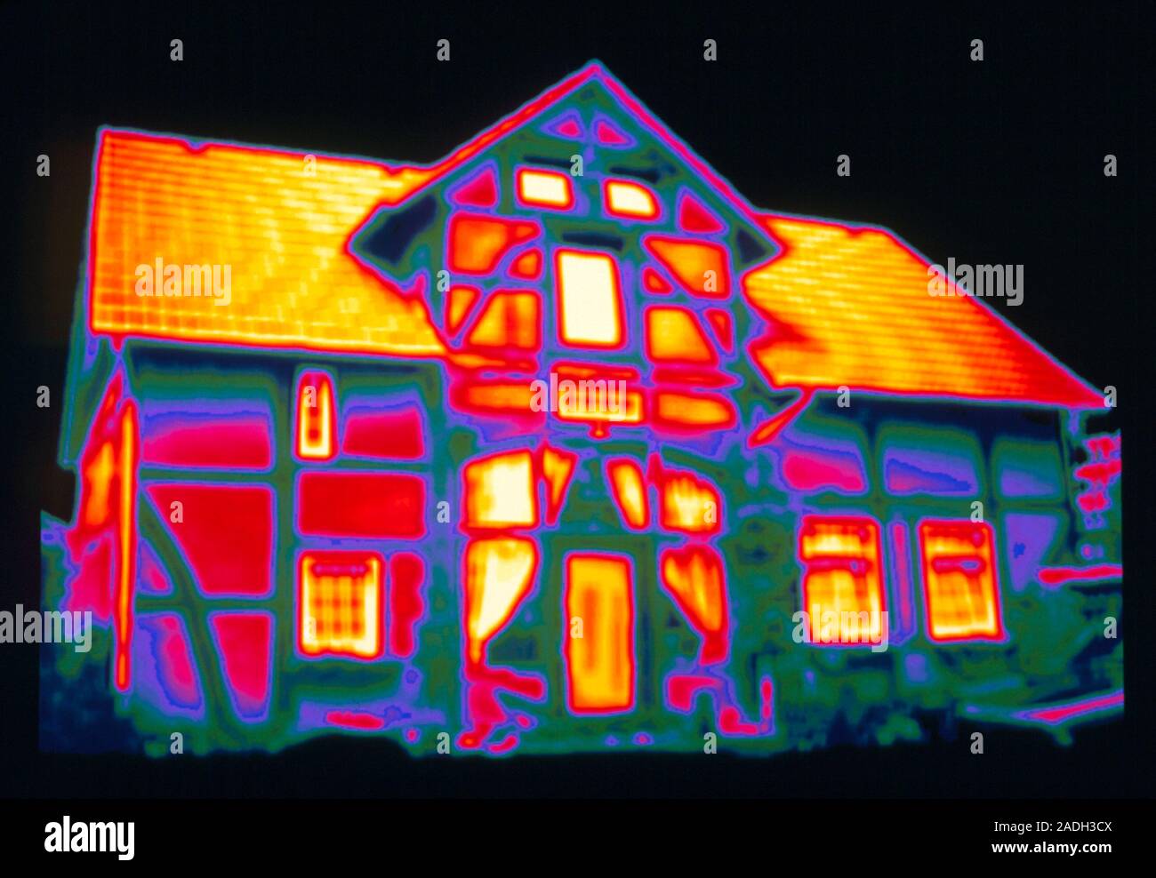 Heat loss. Thermogram of a house showing the distribution of heat over ...