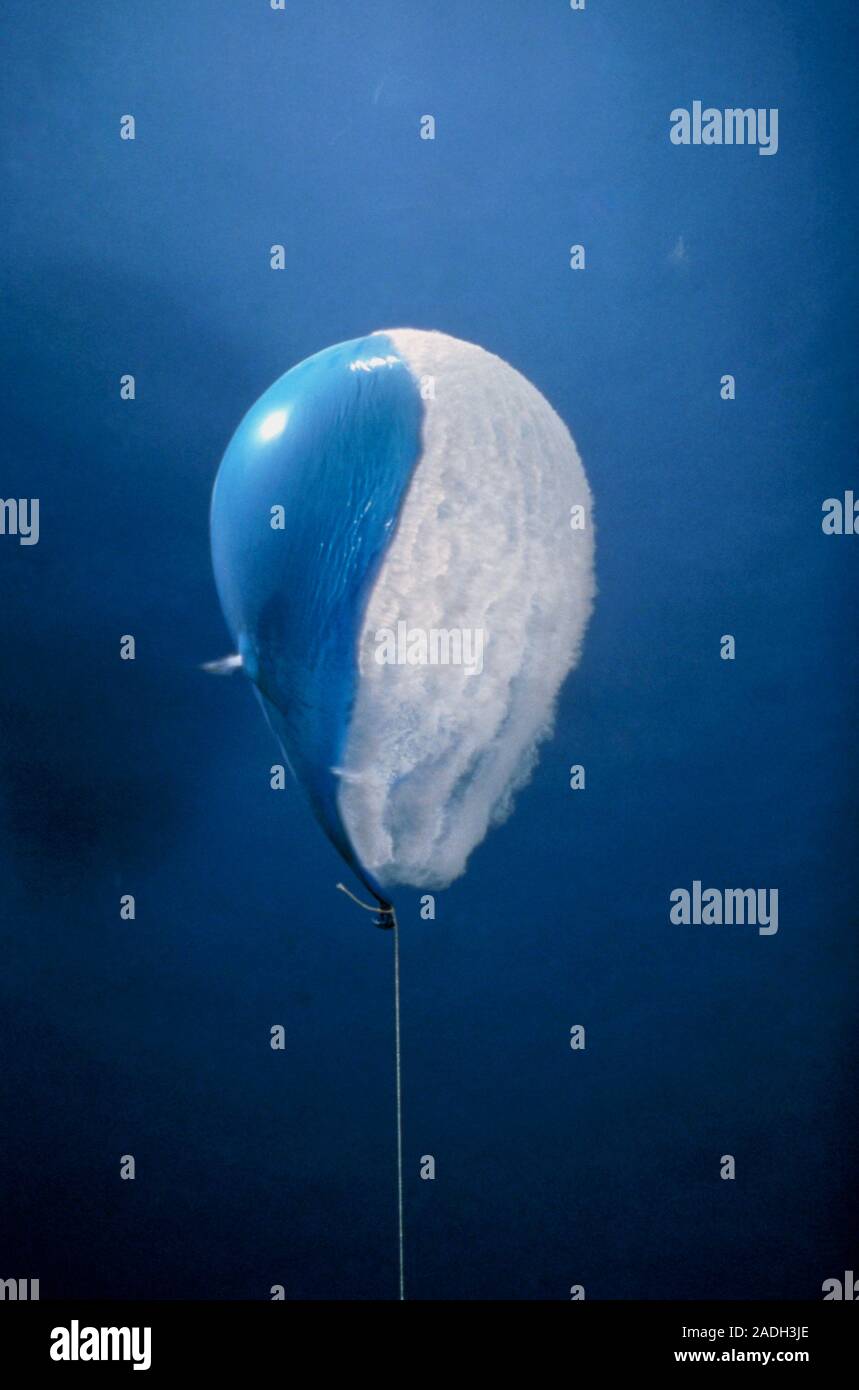 High speed photograph of an air gun pellet ripping through a balloon ...
