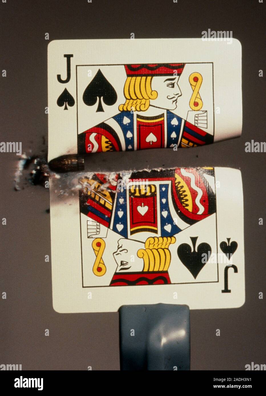 High speed photograph of a . 22 calibre bullet slicing through a ...