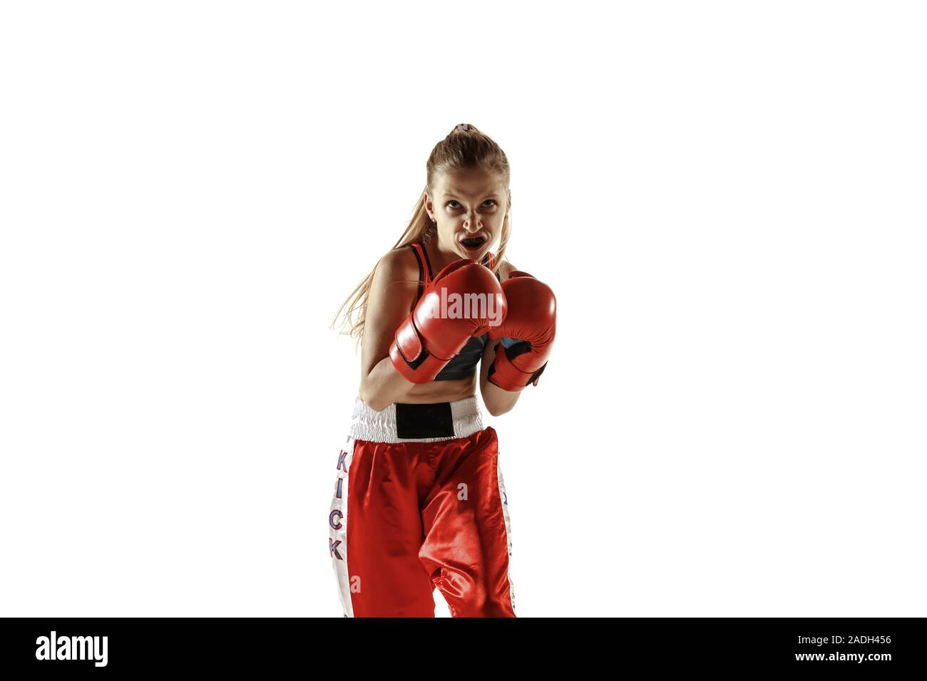 Young female kickboxing fighter training isolated on white background ...