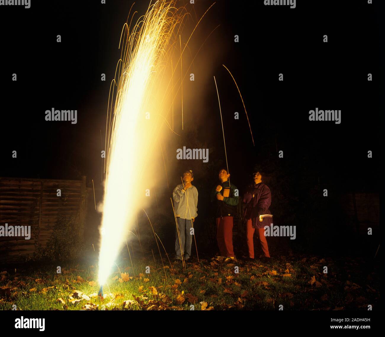 MODEL RELEASED. Firework display in a back garden. Magnesium is used in the production of the ...