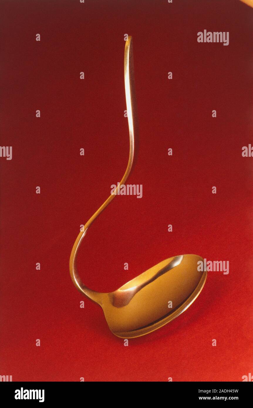 Photograph of a bent spoon Stock Photo - Alamy