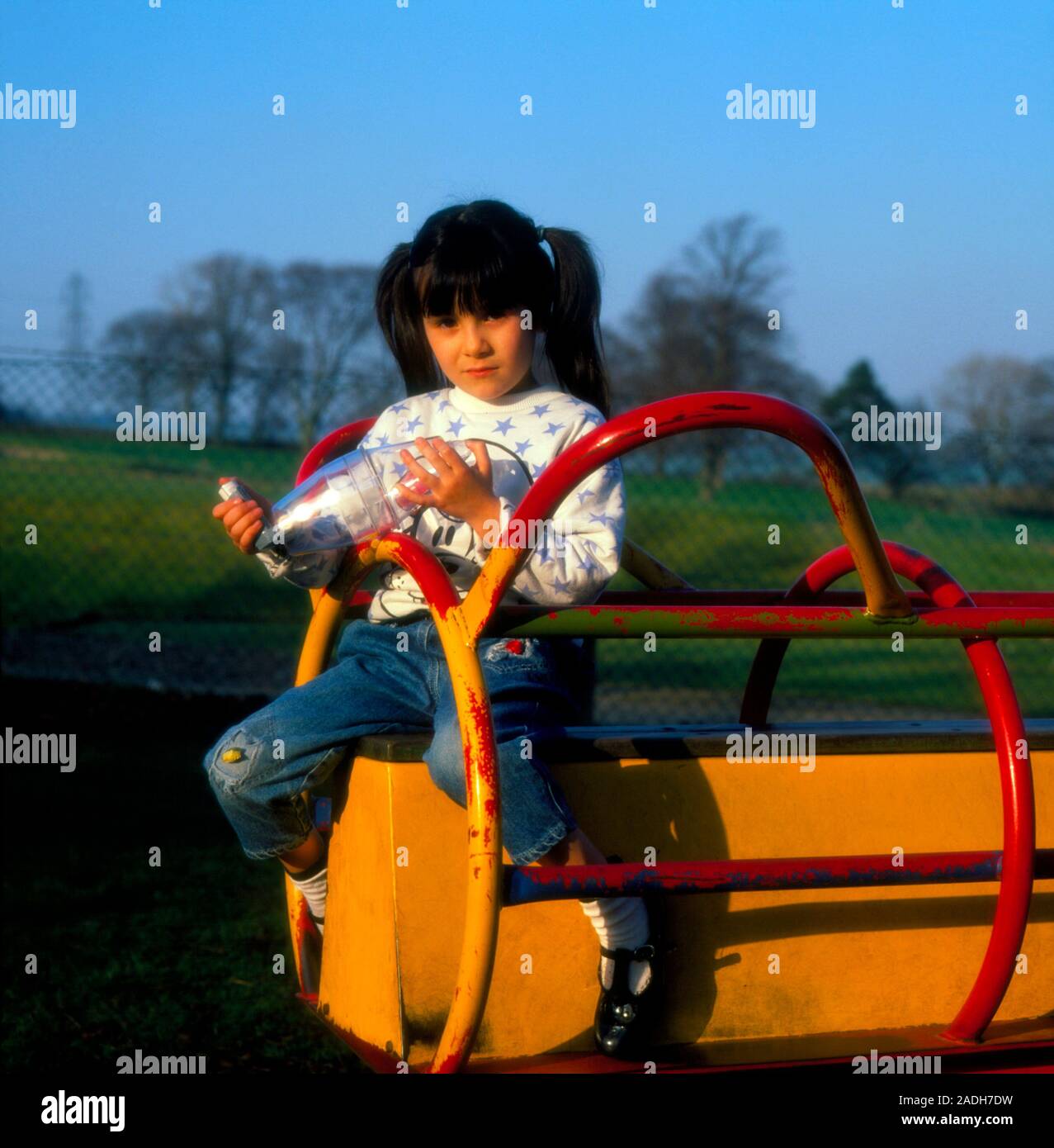 MODEL RELEASED: A girl using an inhaler with a 'Volumatic' adaptor to ...