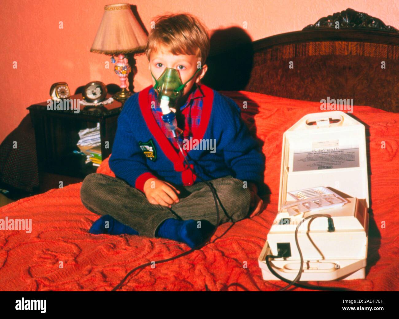 Young boy using a Nebulizer Compression Unit for asthma relief. The ...