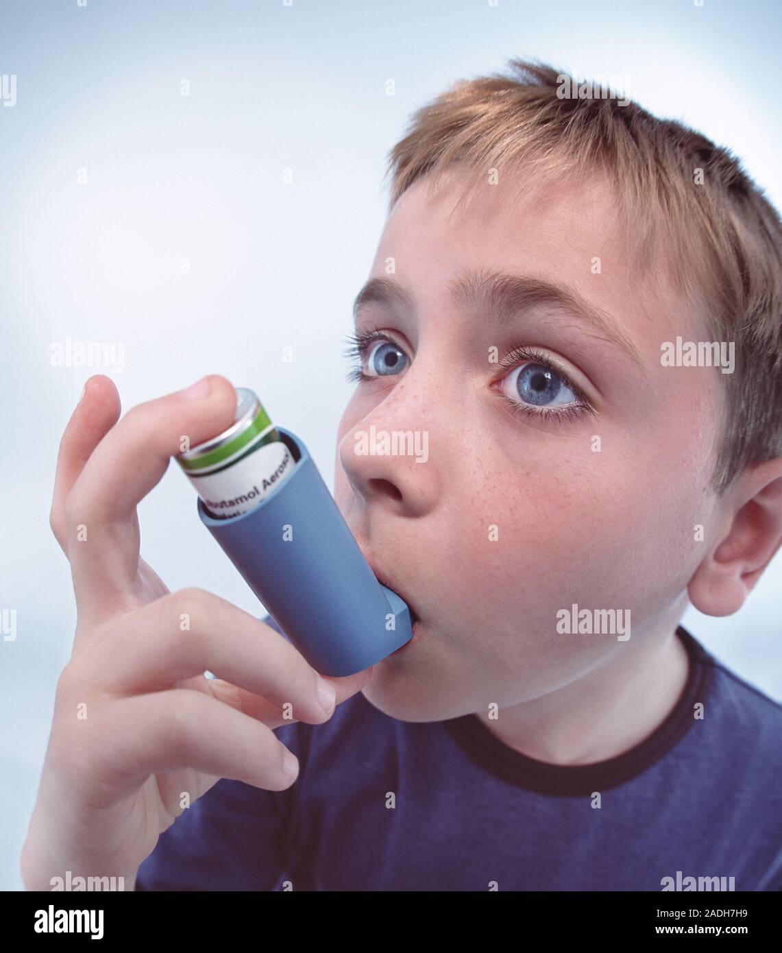 Asthma attack. Boy using an inhaler to treat an asthma attack. Asthma ...