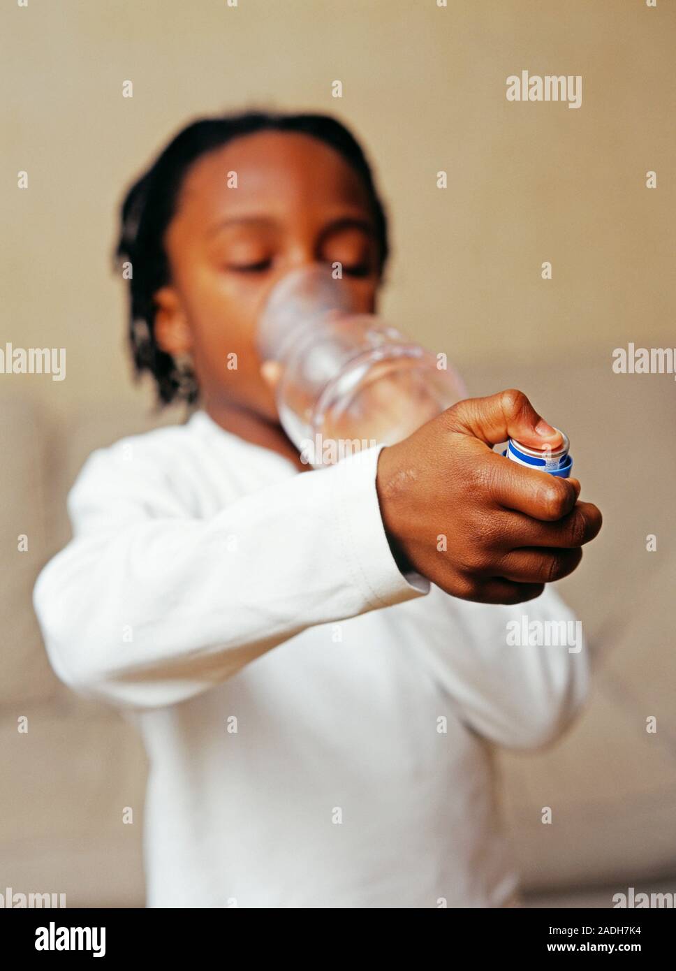 Boy using an asthma inhaler to treat his asthma. The five-year-old boy ...