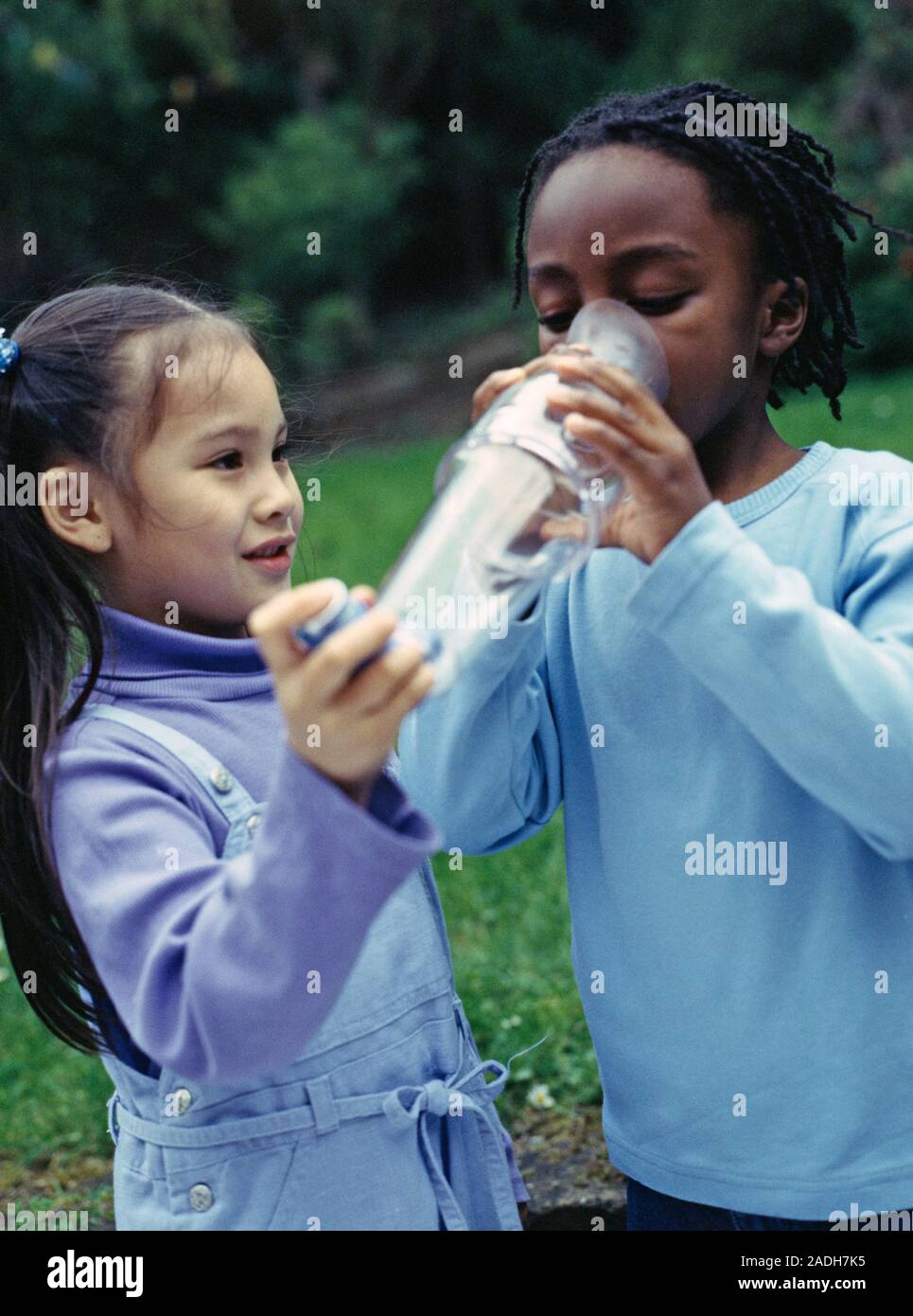 Children using asthma inhaler. Five-year-old girl pumping an aerosol ...