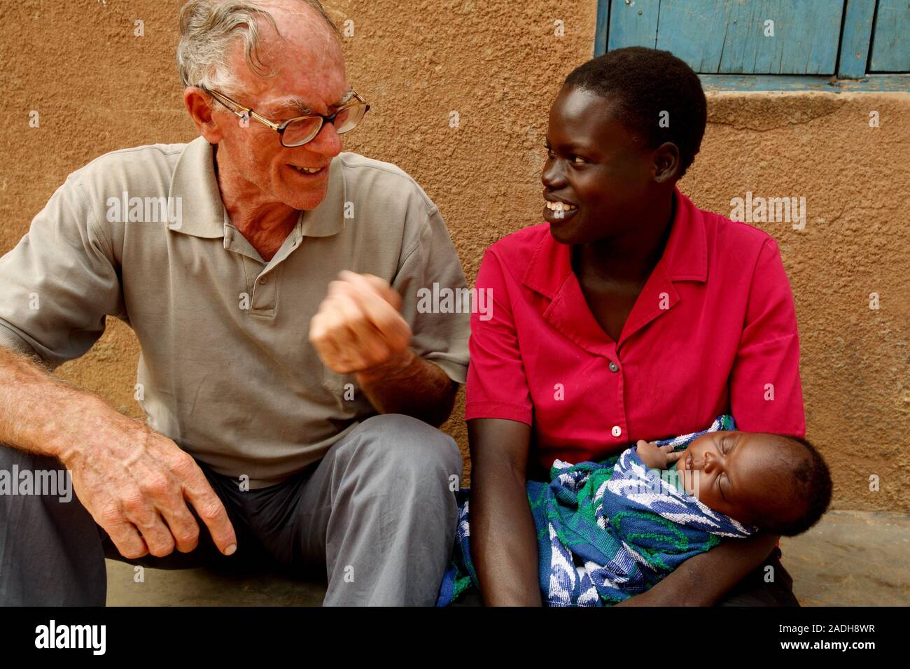 HIV-positive mother and child. Health worker talking to a mother as her ...