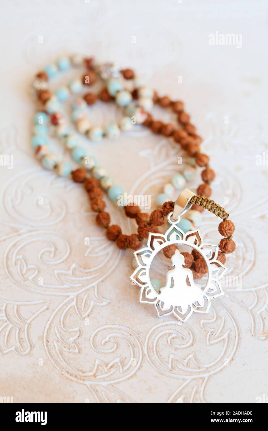 Jewelry mala necklace with natural mineral beads on white wooden ...