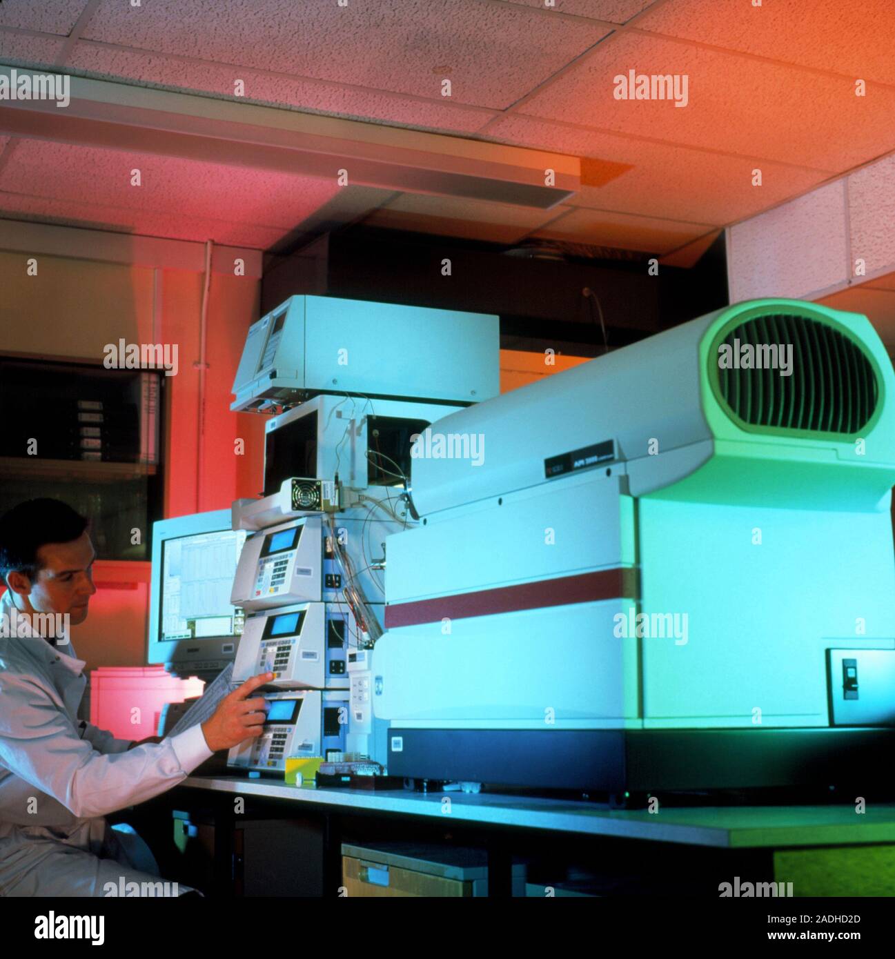 Cancer drug research. Male researcher operating a liquid chromatography ...