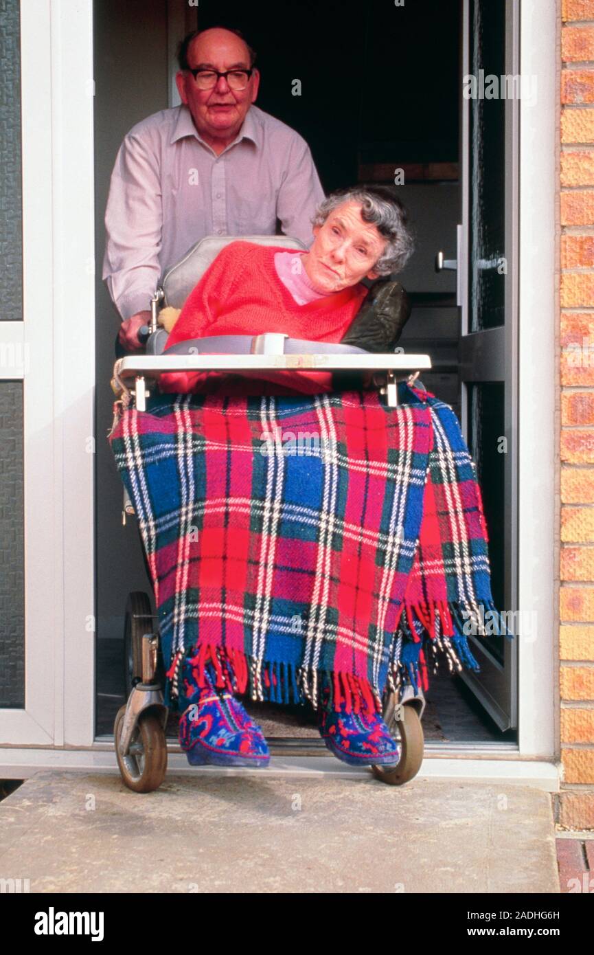 Huntington's chorea. Elderly woman in a wheelchair suffering from ...