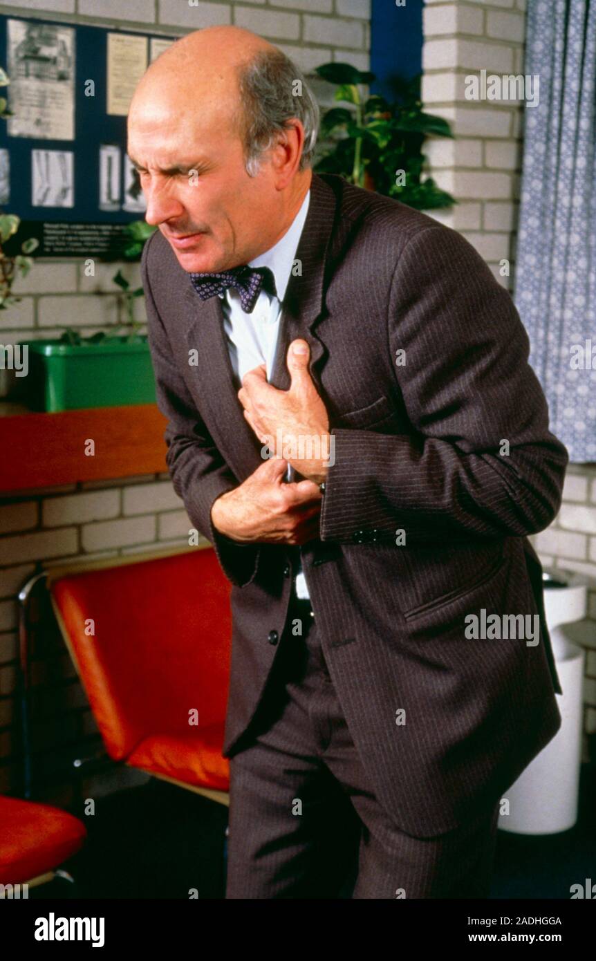 A middle-aged man suffering from angina pectoris, an intense pain in ...
