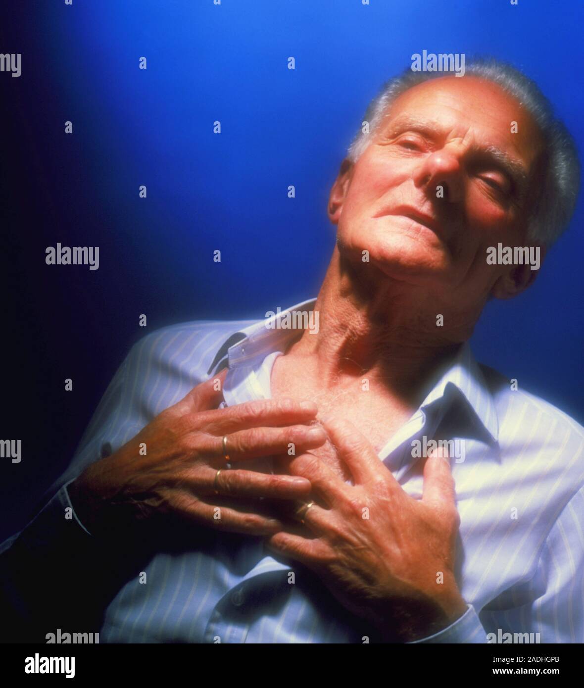 Angina or heart attack. Elderly man clutching his chest during angina ...