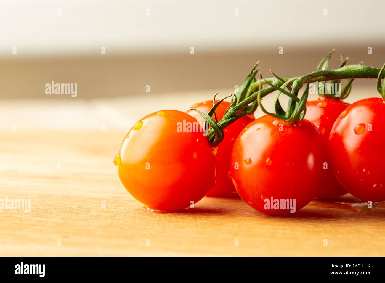 Close up photo of the fresh red cherry tomatoes lying on the table and ...