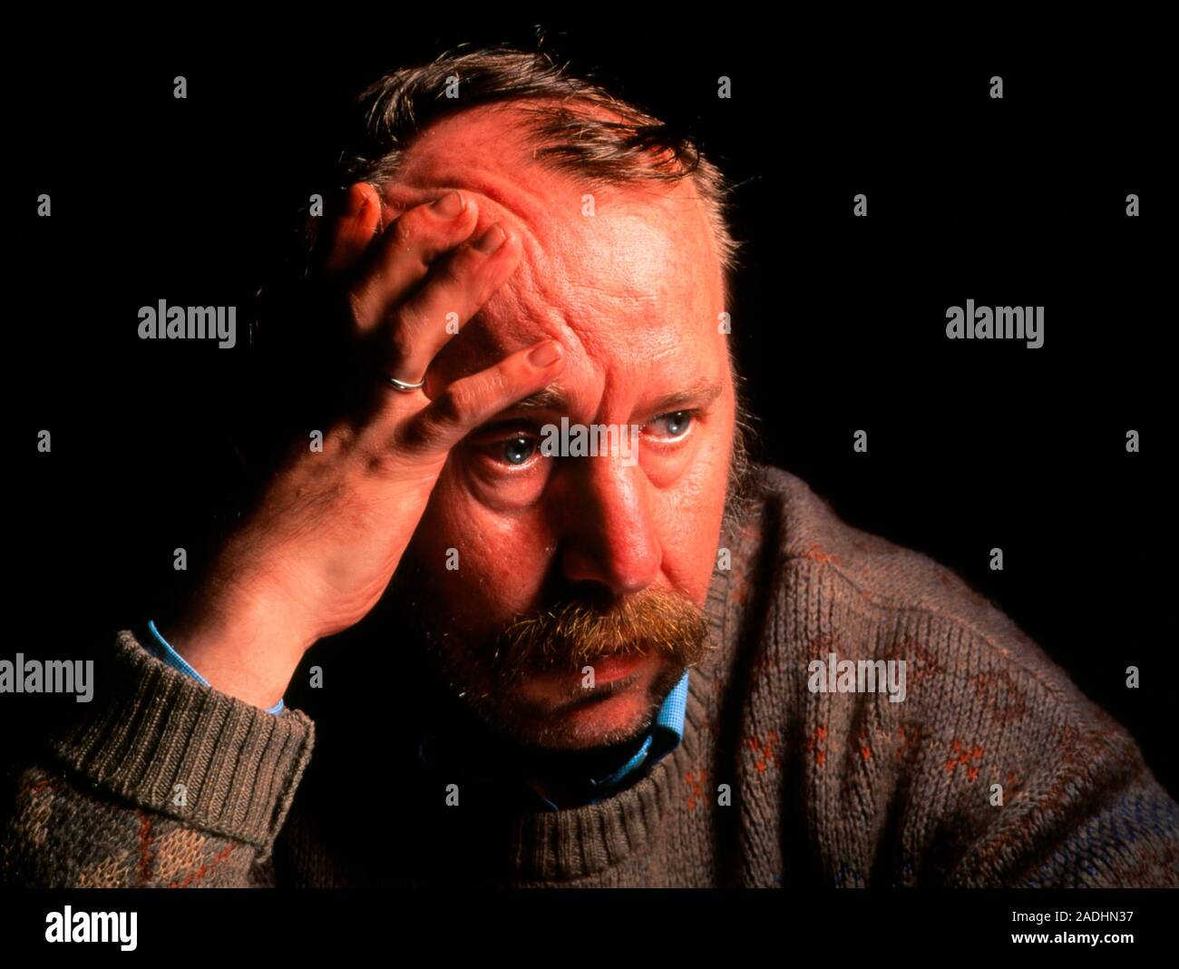 MODEL RELEASED. Depression. Face of a depressed man who looks intensely ...