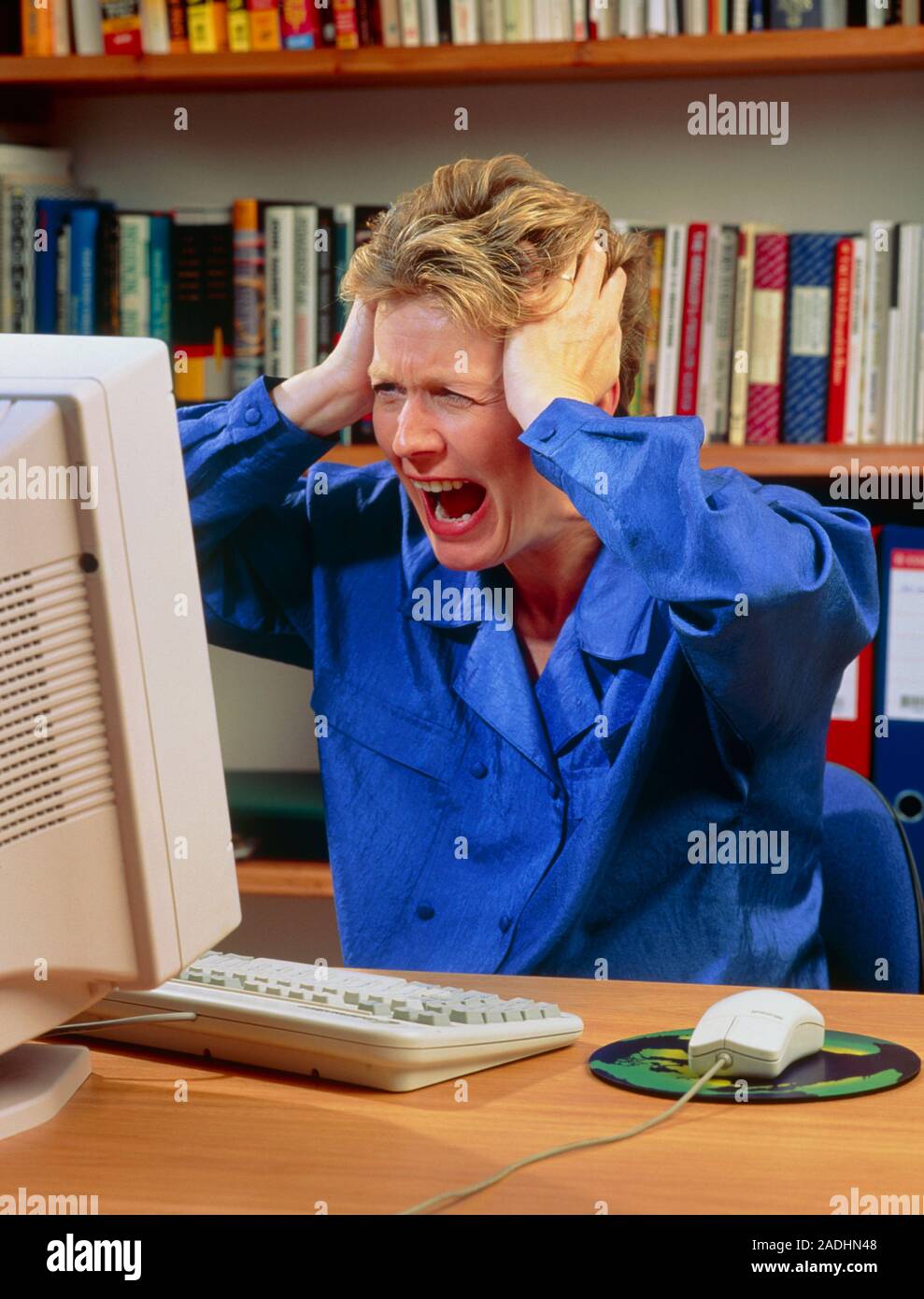Stress. Stressed businesswoman holding her head and angrily shouting at ...