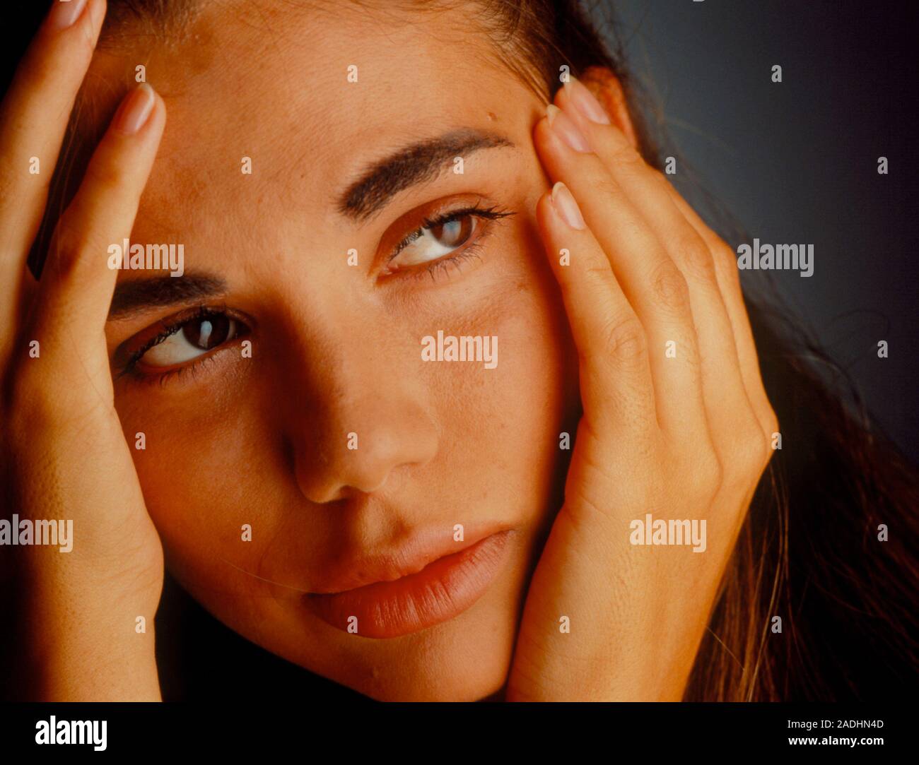 Sadness or depression. Front view of the face of a teenage girl looking ...